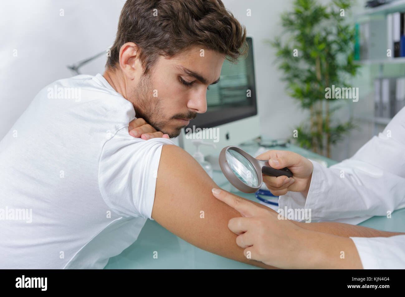 close-up of doctors hands checking mans moles Stock Photo - Alamy