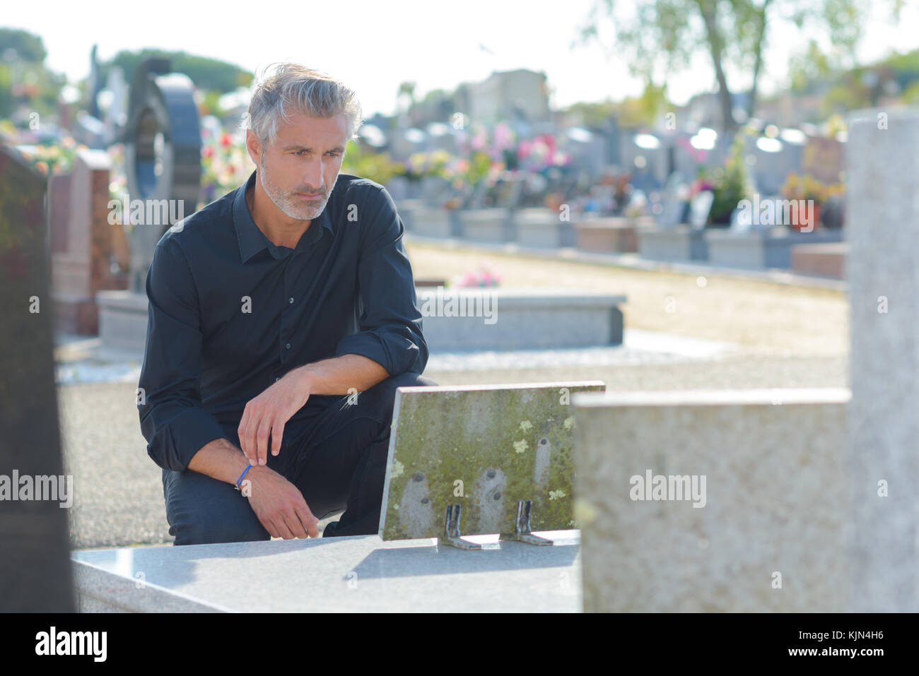 mourning at a grave Stock Photo - Alamy