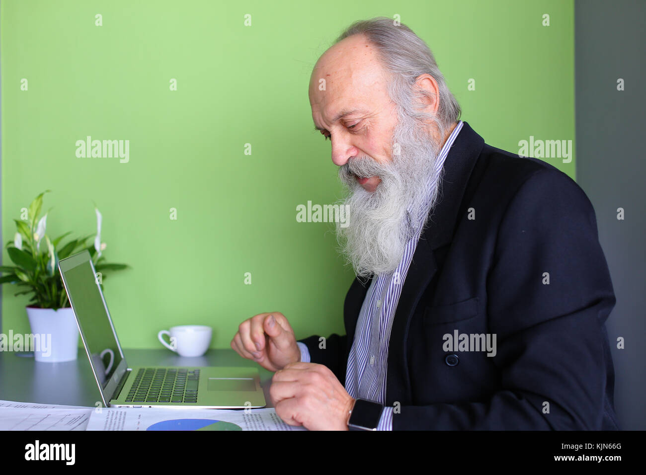 Retired old political man works at computer in office in daytime Stock ...