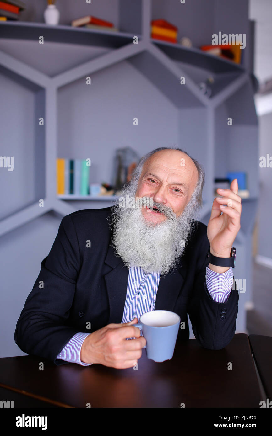 Portrait of smart elderly man who reflects on life and posing wi Stock ...