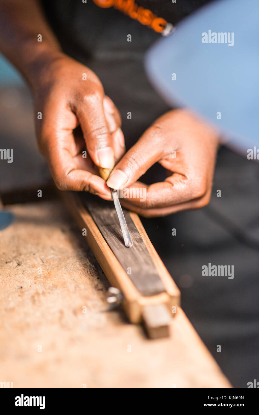 Hands of a afro american man working the wood with tools Stock Photo ...