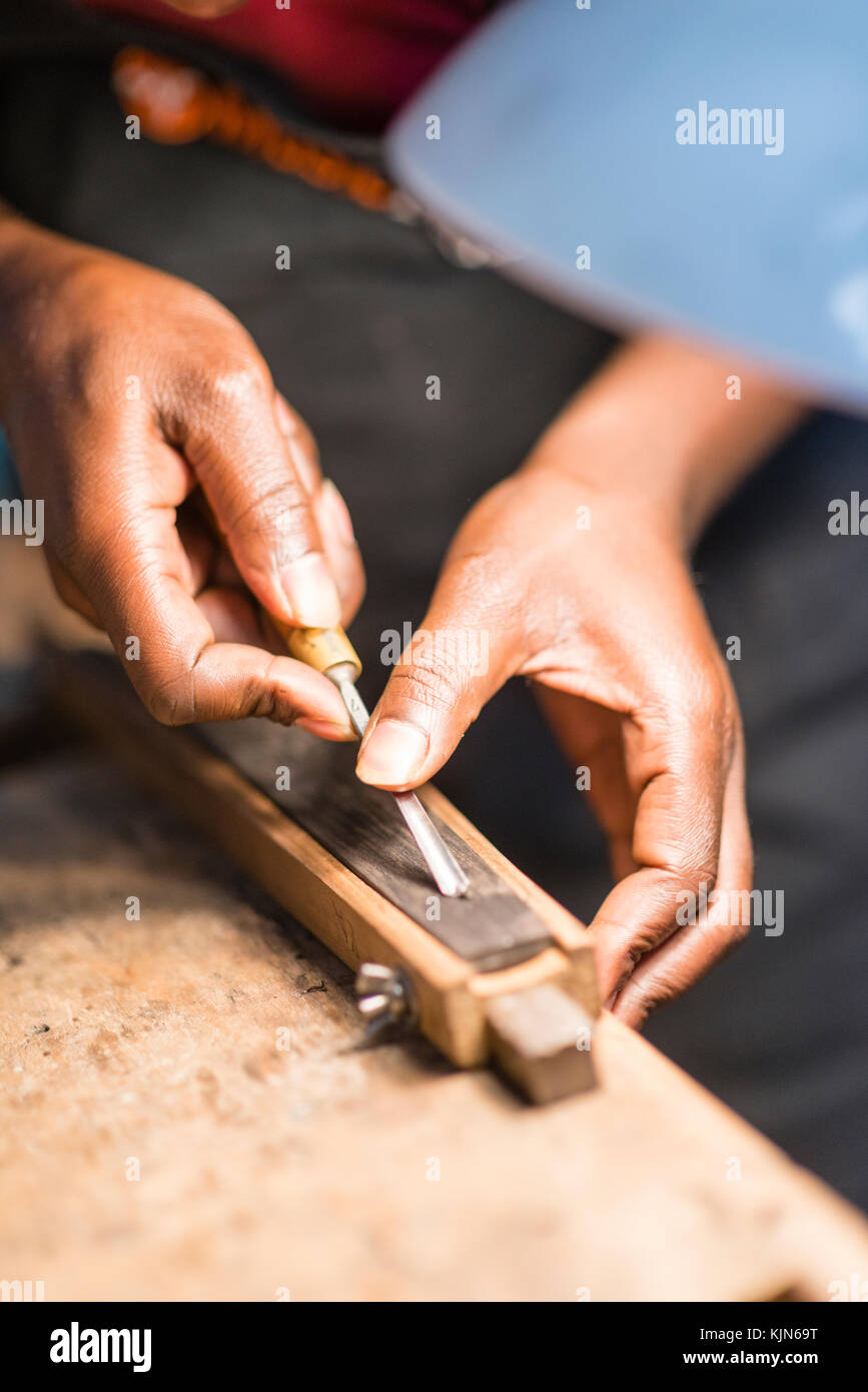 Hands of a afro american man working the wood with tools Stock Photo ...