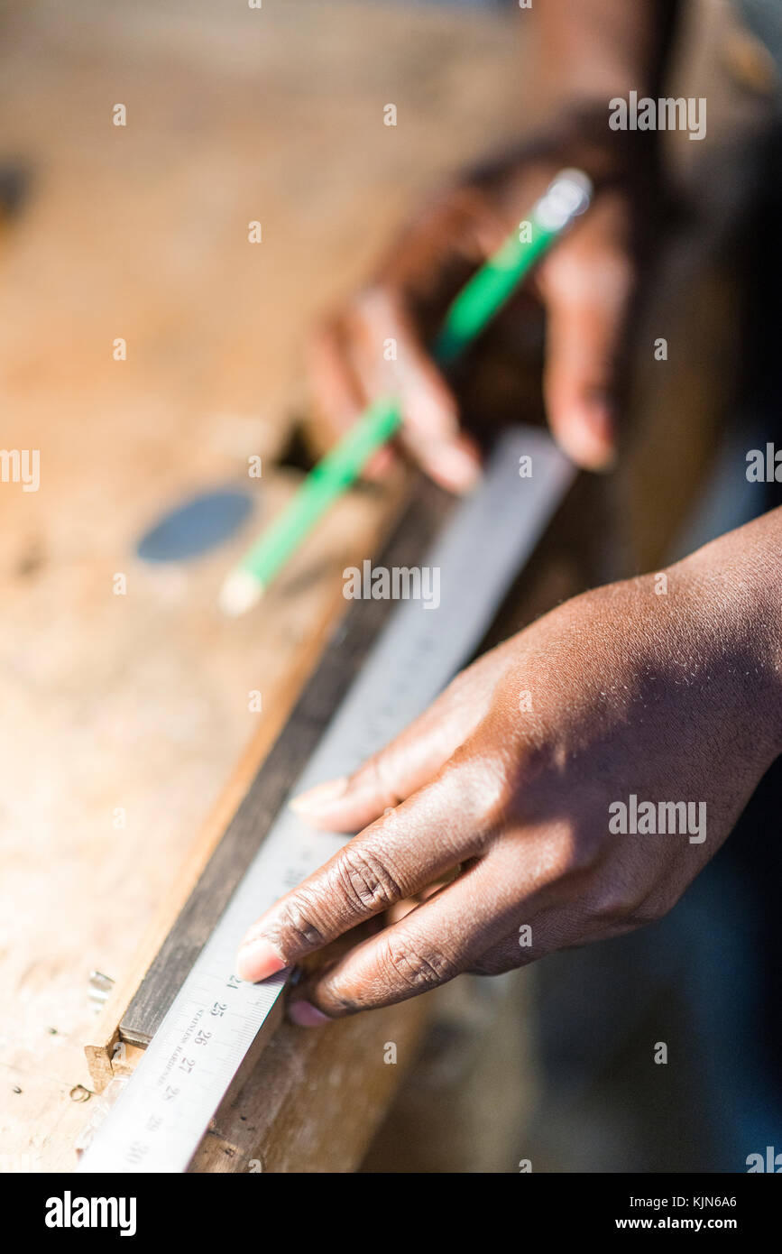 Hands of a afro american man working the wood with tools Stock Photo ...