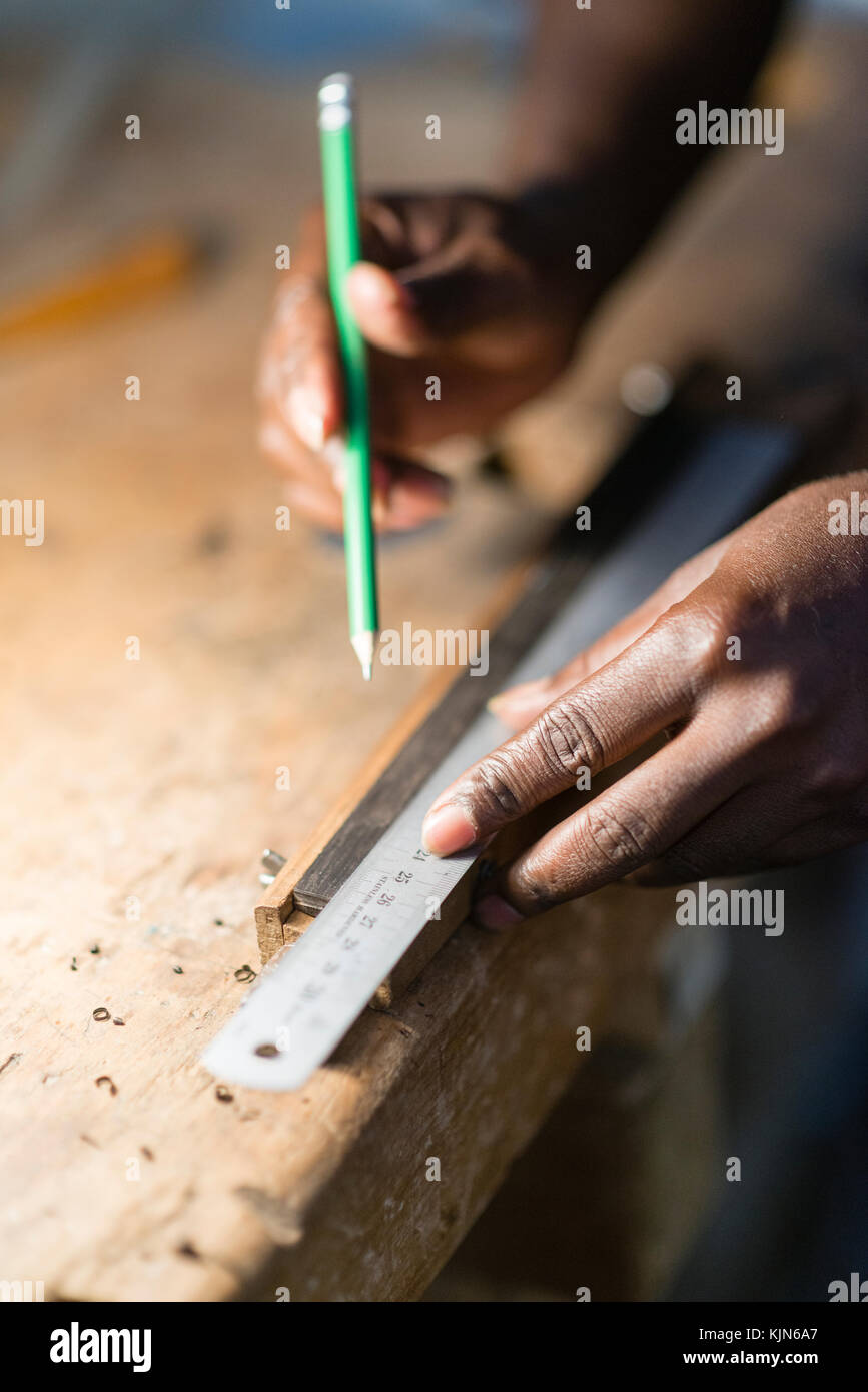 Hands of a afro american man working the wood with tools Stock Photo ...