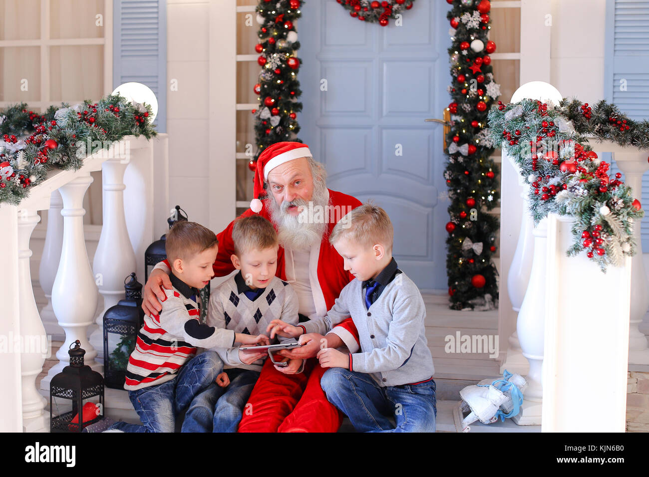 Happy children playing with Santa Claus Stock Photo - Alamy