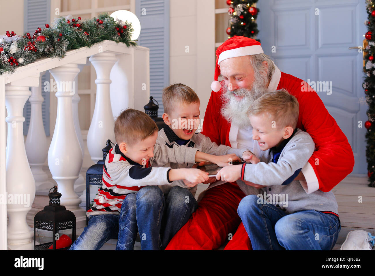 Father Christmas joking with naughty boy Stock Photo - Alamy