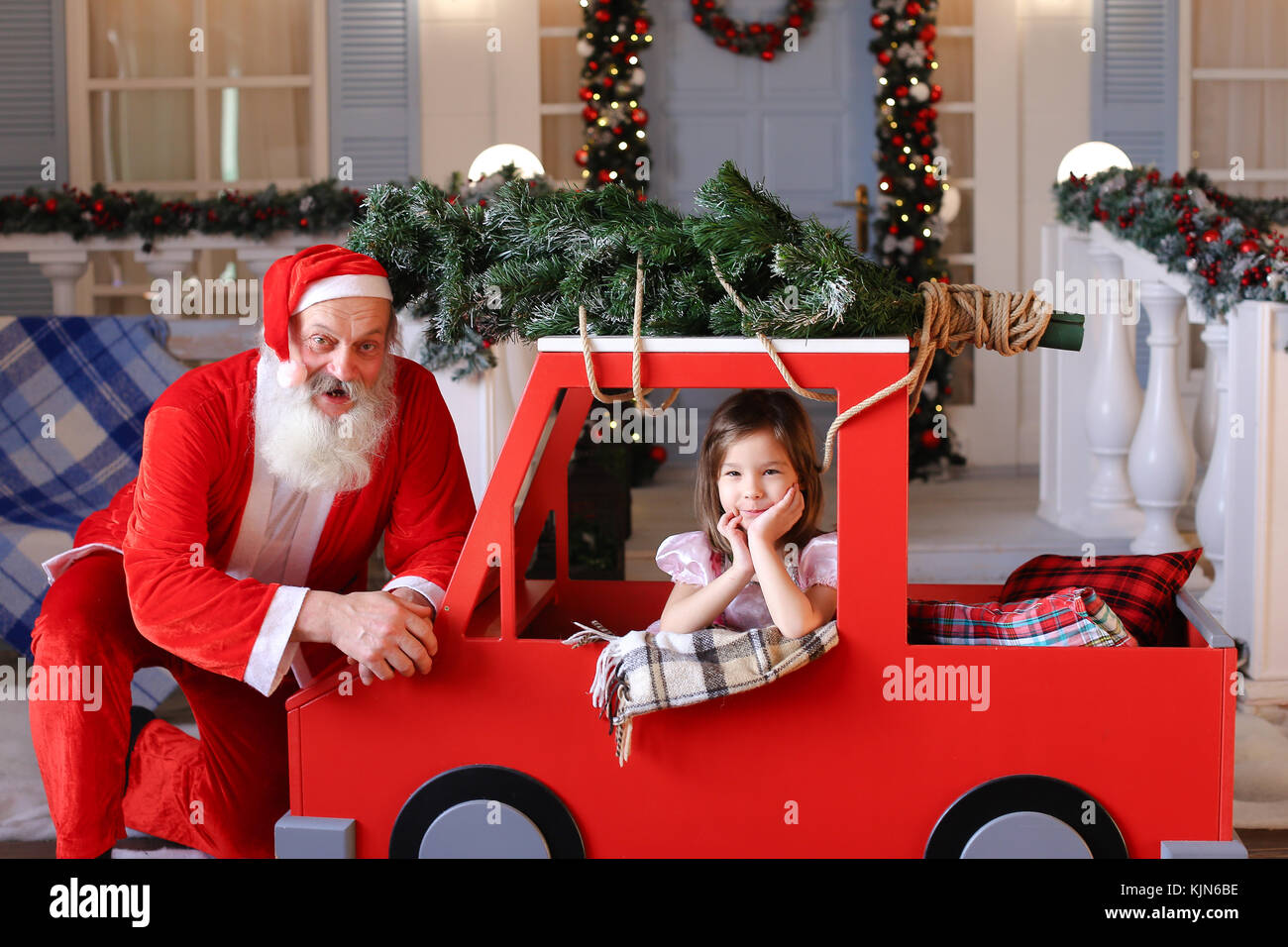 Funny Father Christmas doing thumbs up near gladden little princ Stock ...