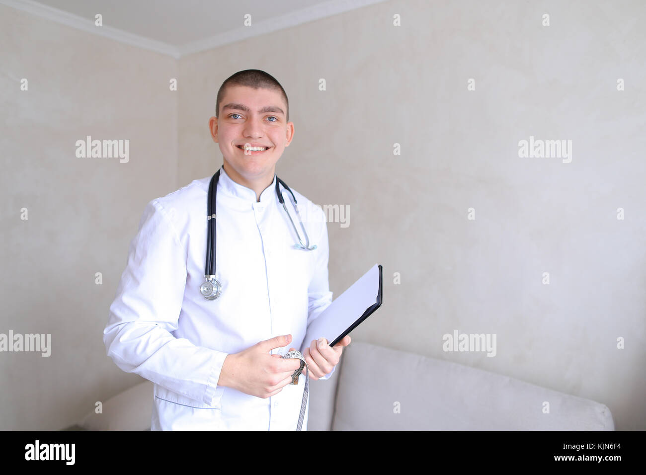 Professional male therapist looks at camera with smile and stand Stock ...
