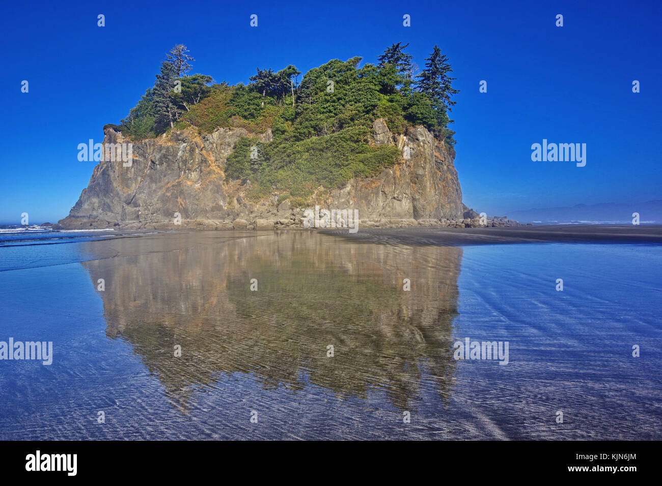 Abbey Island reflected in water at Ruby Beach in Olympic National Park ...