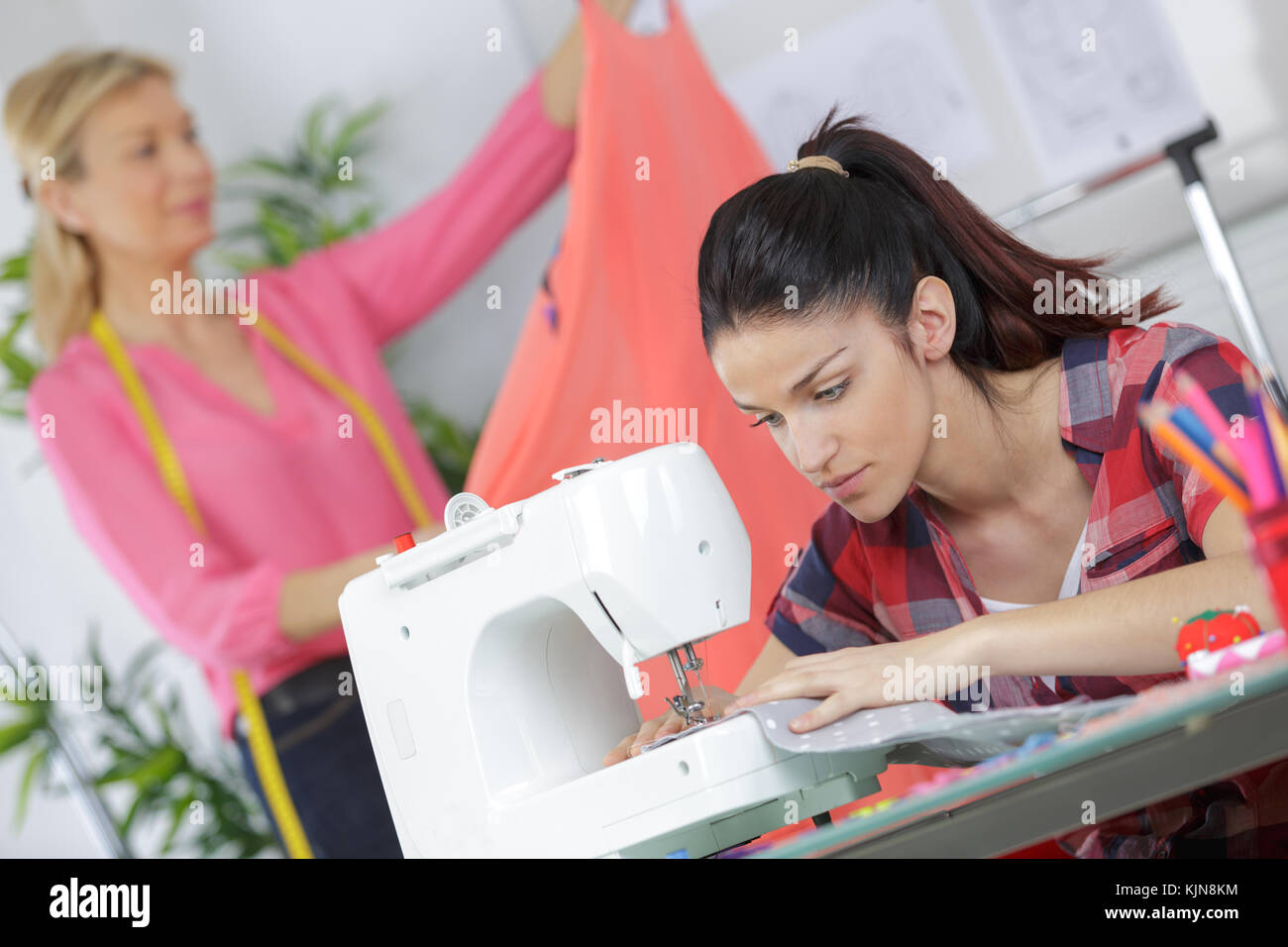 young woman working with a sewing machine Stock Photo - Alamy