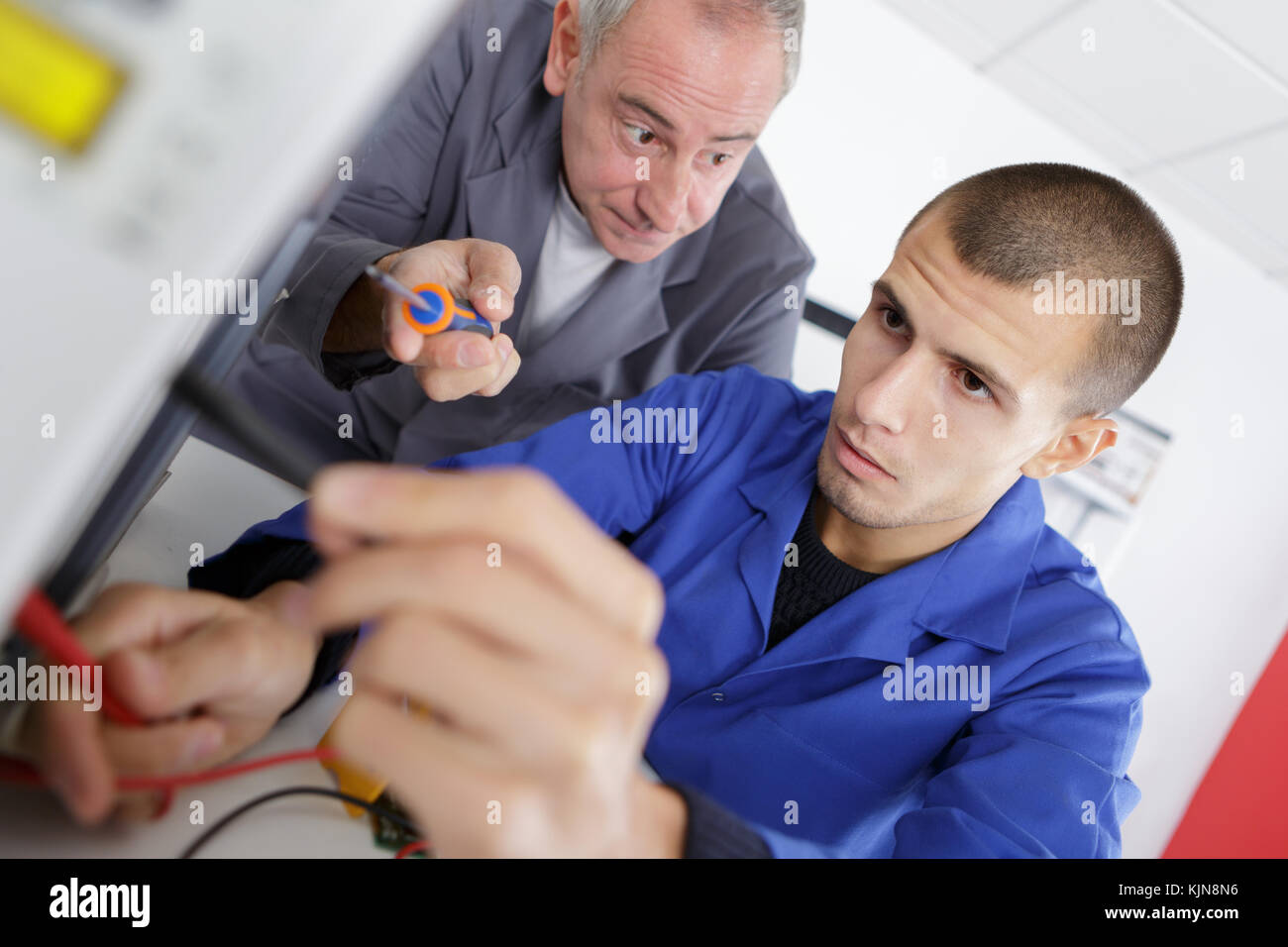 young apprentice using tools Stock Photo - Alamy