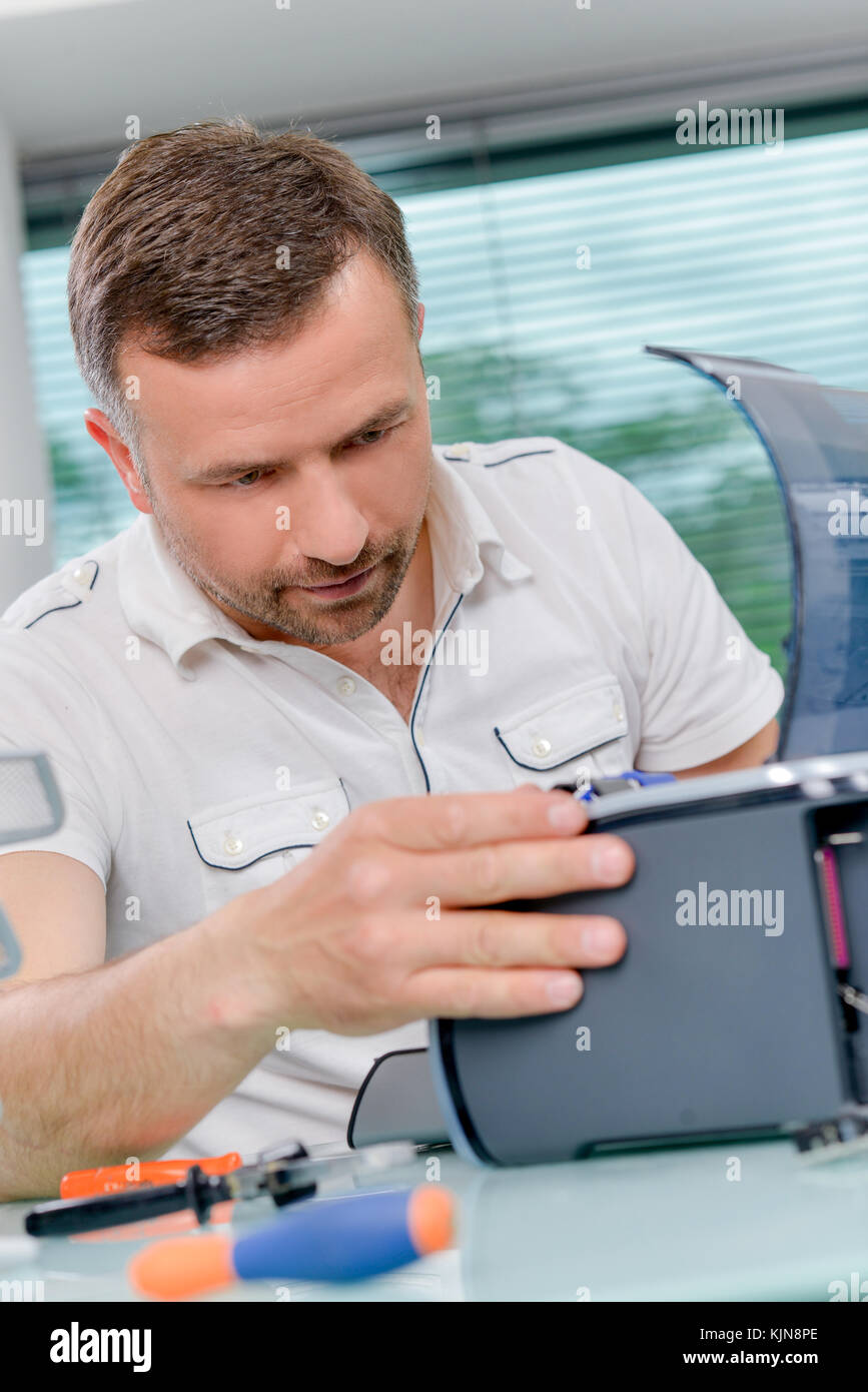 Man fixing a printer Stock Photo - Alamy