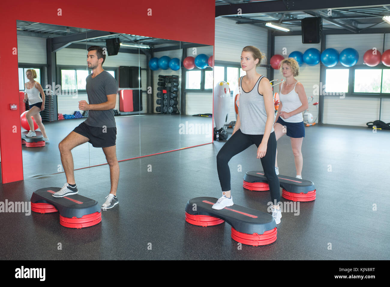 young sporty people training with steppers in gym Stock Photo - Alamy