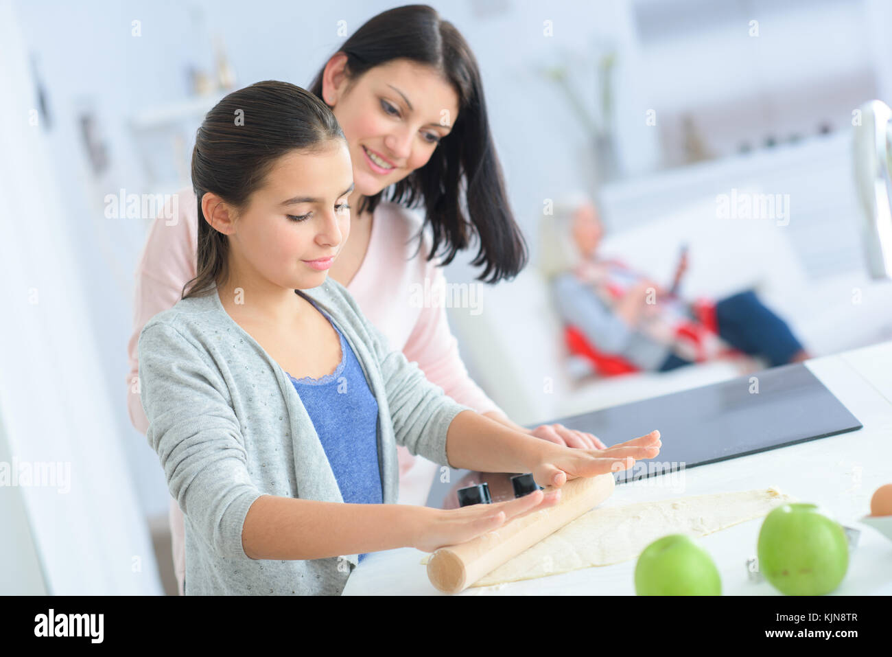 smiling mother and daughter baking a pie Stock Photo - Alamy