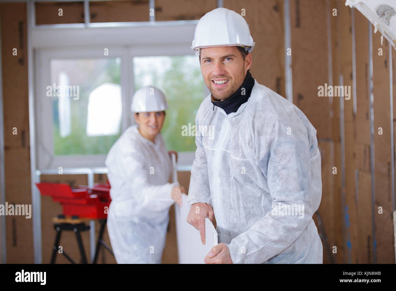Two construction site workers carrying hi-res stock photography and ...