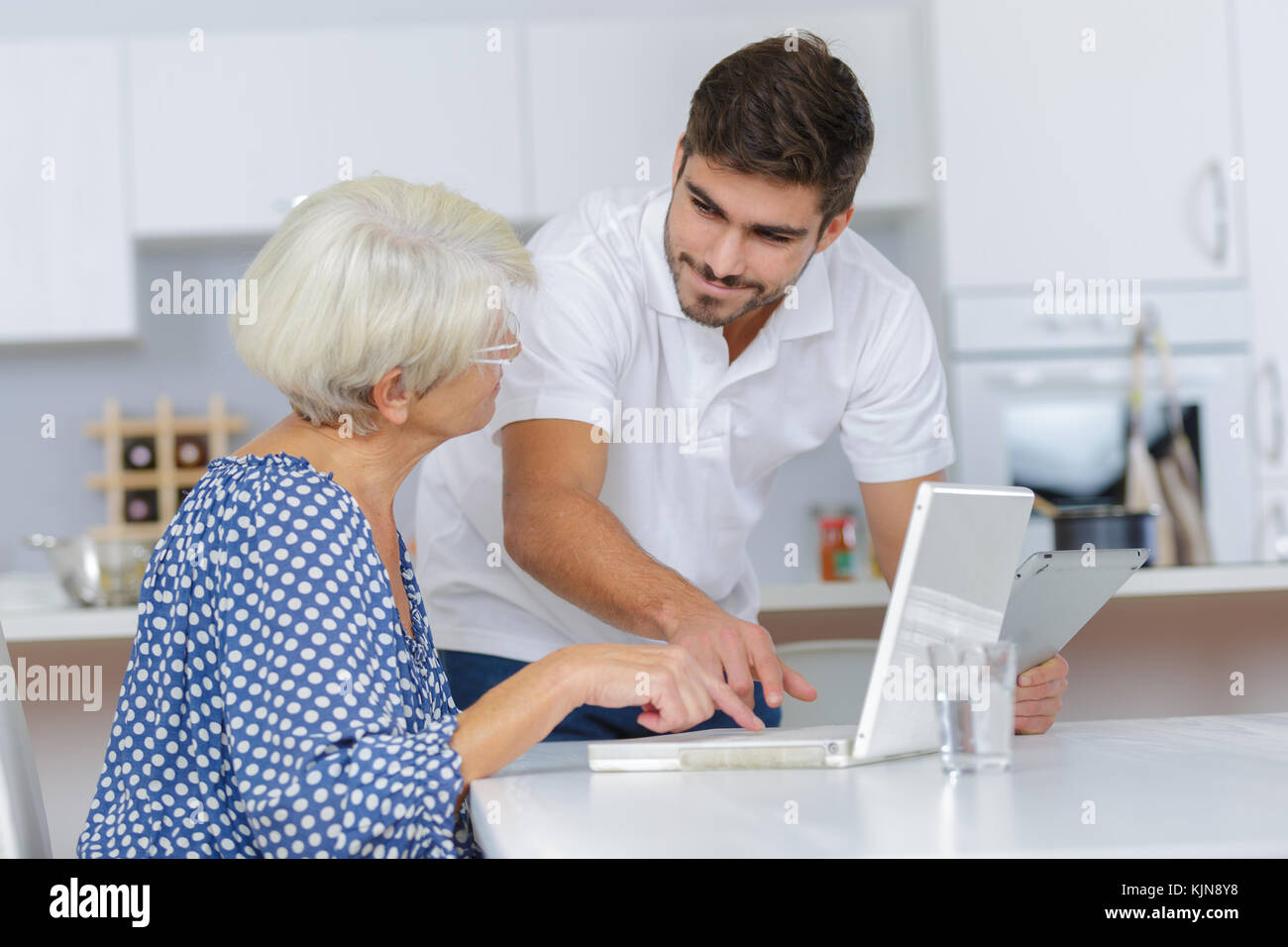 adult grandson teaching his grandma using a computer Stock Photo - Alamy