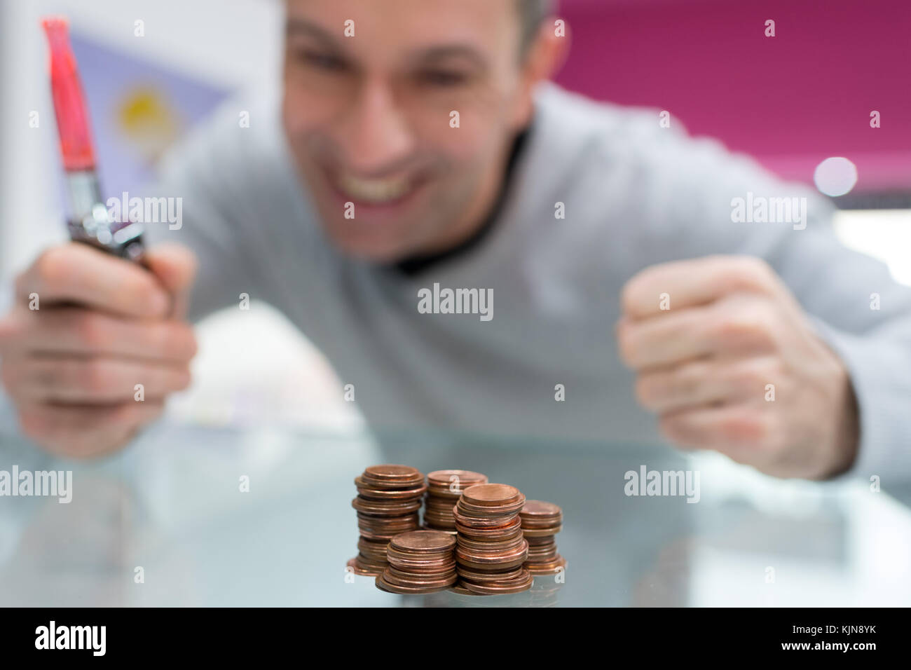 happy man with coin stack growing Stock Photo - Alamy