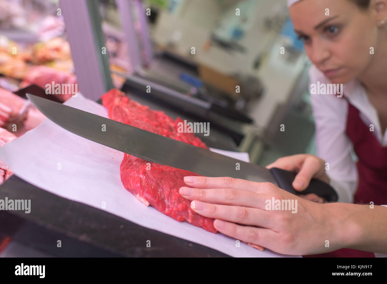 female butcher cutting meat Stock Photo - Alamy