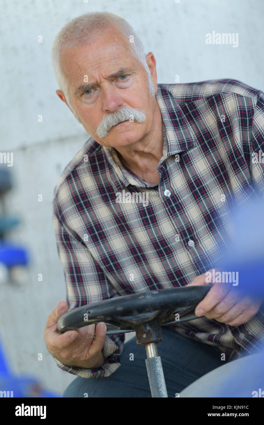 senior worker driving a vehicle in a factory Stock Photo - Alamy