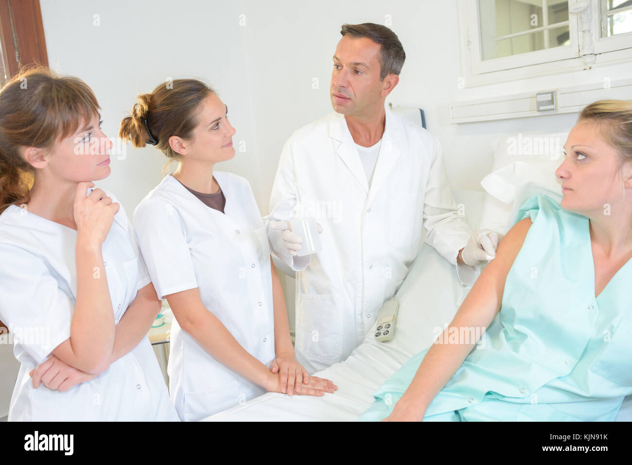Medical staff with patient Stock Photo - Alamy