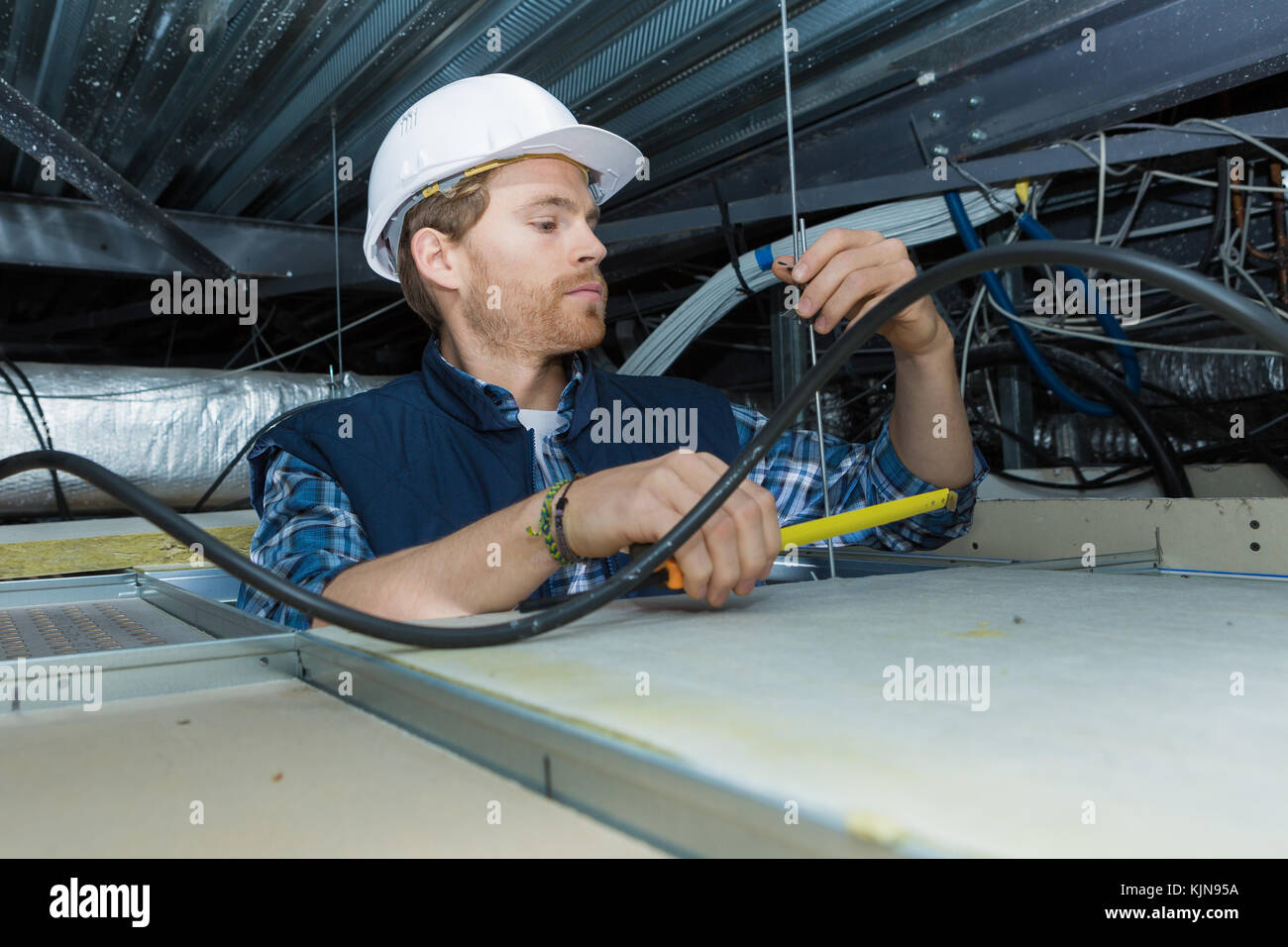 electrician fitting a cable for ceiling light Stock Photo - Alamy