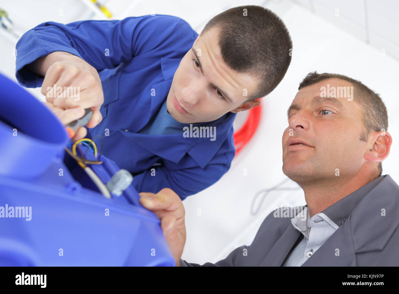 mechanic and apprentice working Stock Photo - Alamy