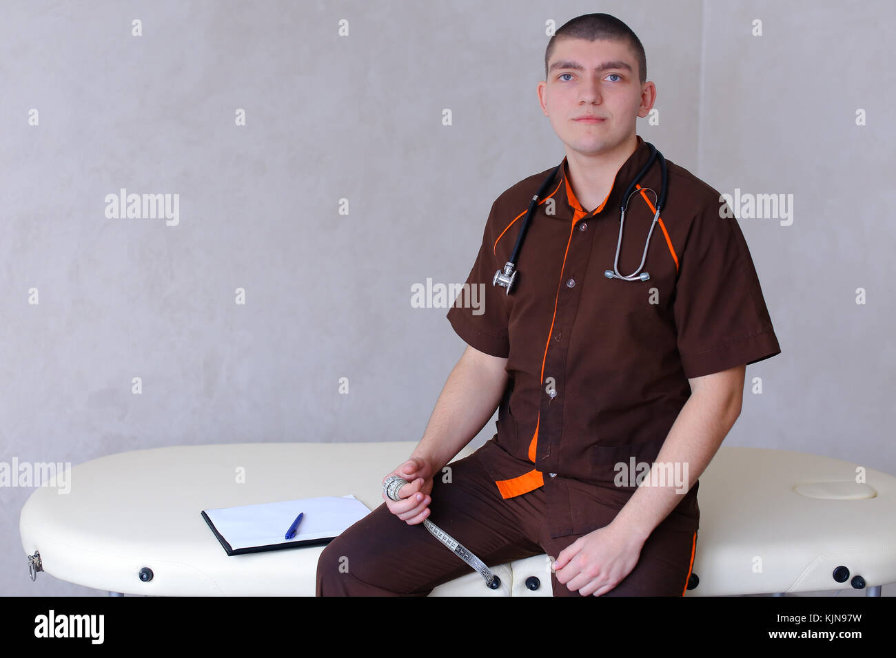 Professional male therapist looks at camera with smile and sitti Stock ...