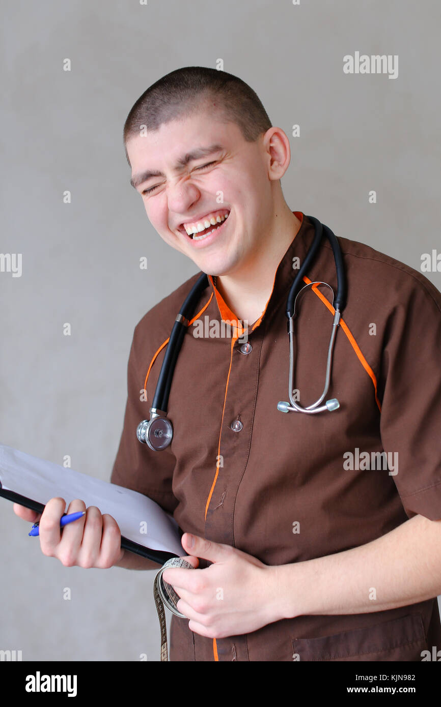 Professional male therapist looks at camera with smile and stand Stock ...