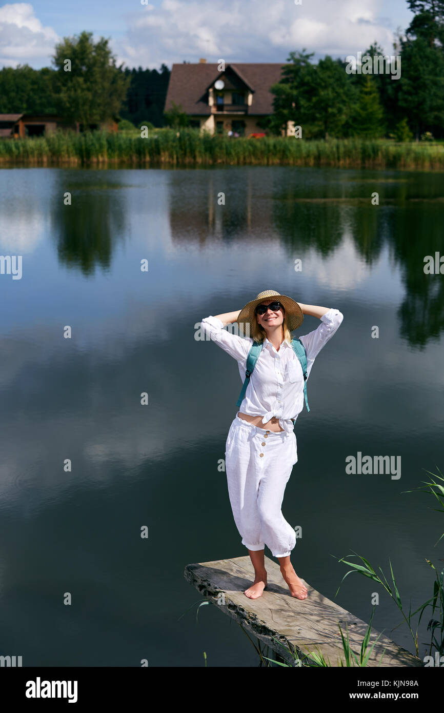 Young woman resting near lake Stock Photo - Alamy