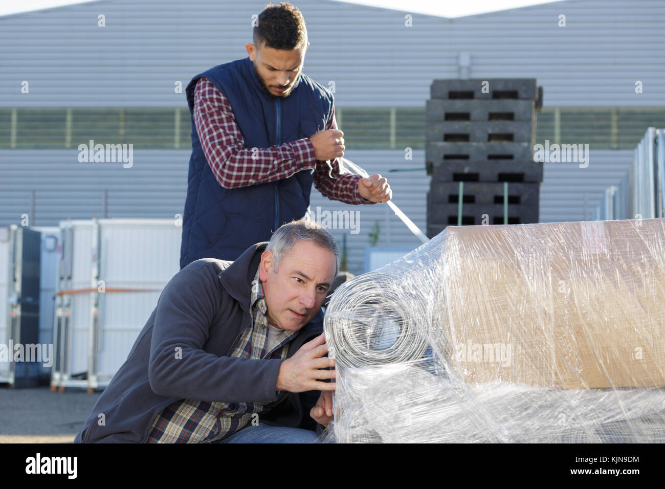 men working outdoors a factory Stock Photo - Alamy