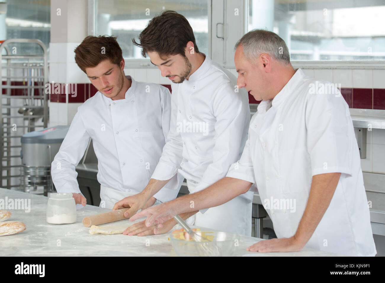 chef with apprentices at work Stock Photo - Alamy