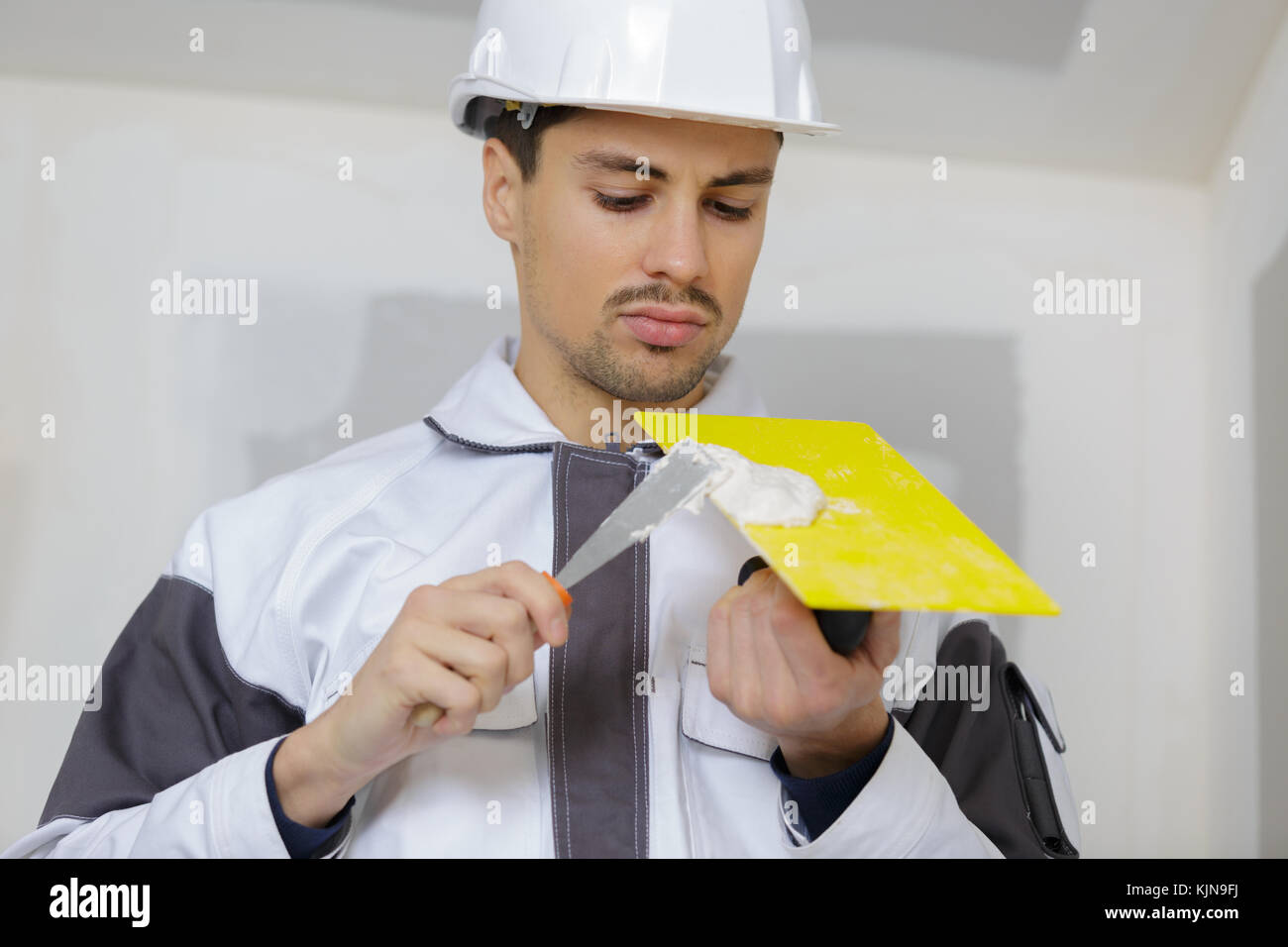 master plasterer with a spatula Stock Photo - Alamy