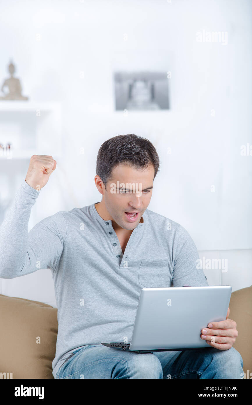 successful excited man with laptop Stock Photo - Alamy