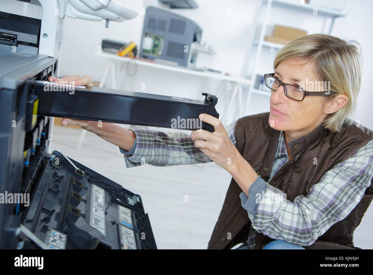 female technician fixing the office printer Stock Photo - Alamy