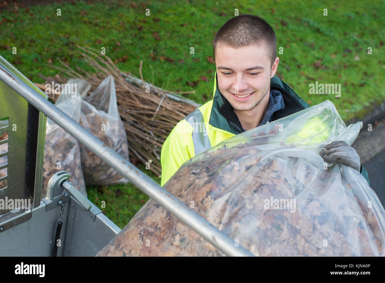 Young worker loading bag hi-res stock photography and images - Alamy