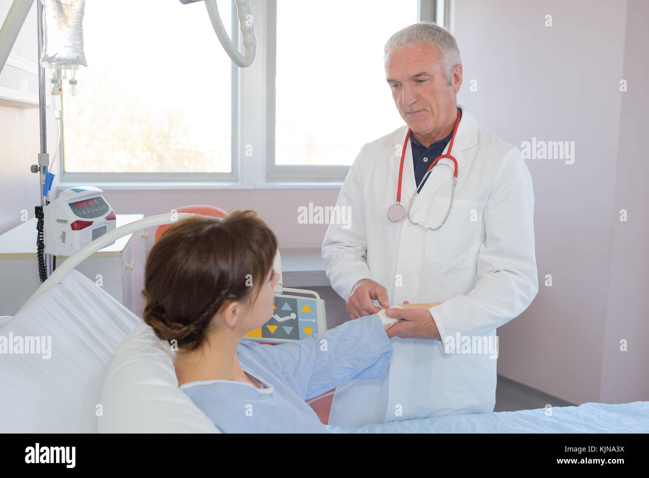 doctor checking on a patient Stock Photo - Alamy