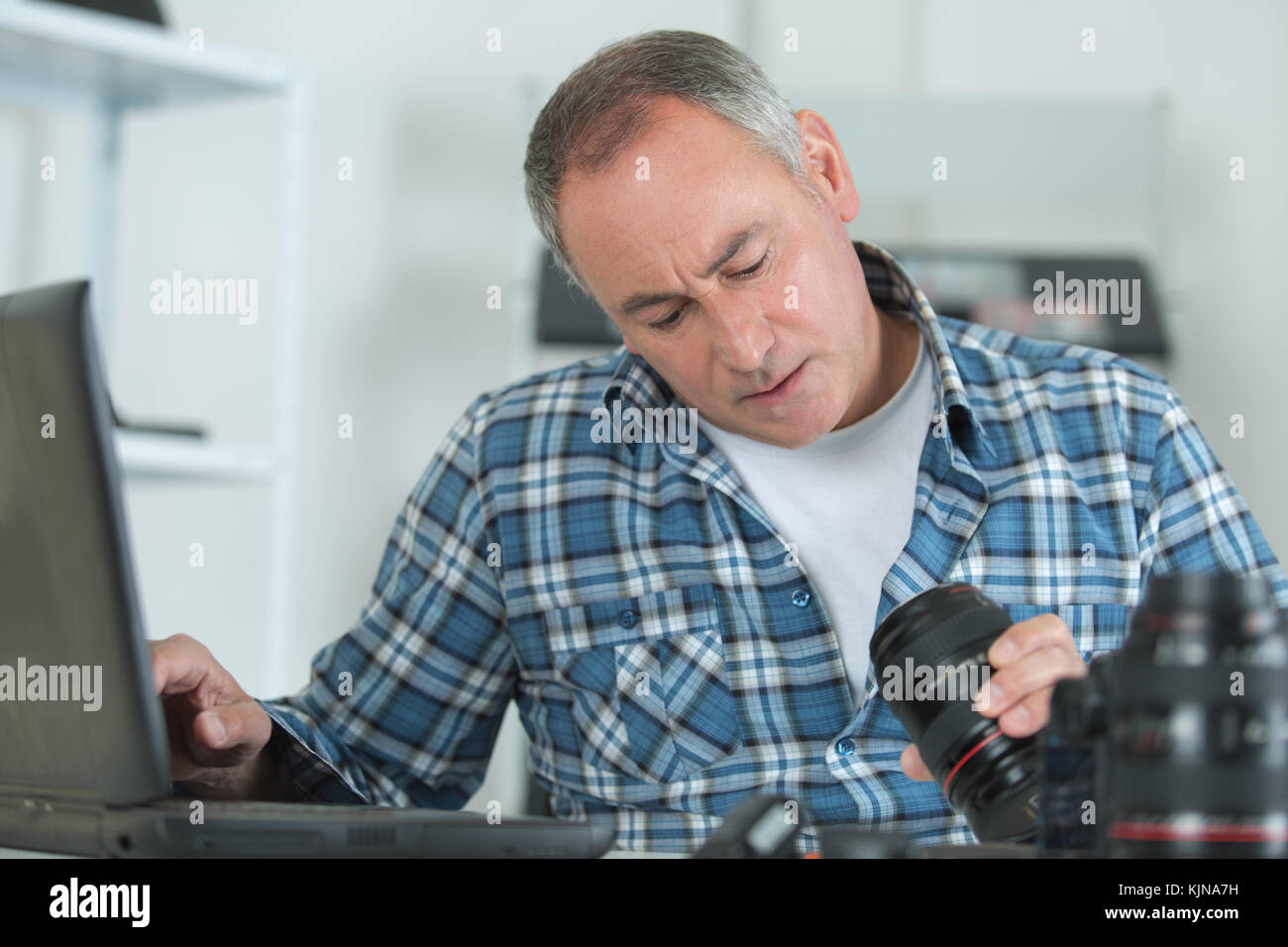 man cleaning lens of his digital camera with special brush Stock Photo ...