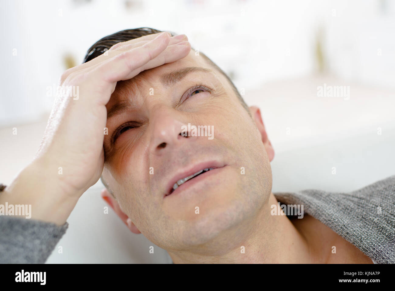Closeup of man holding his head Stock Photo - Alamy