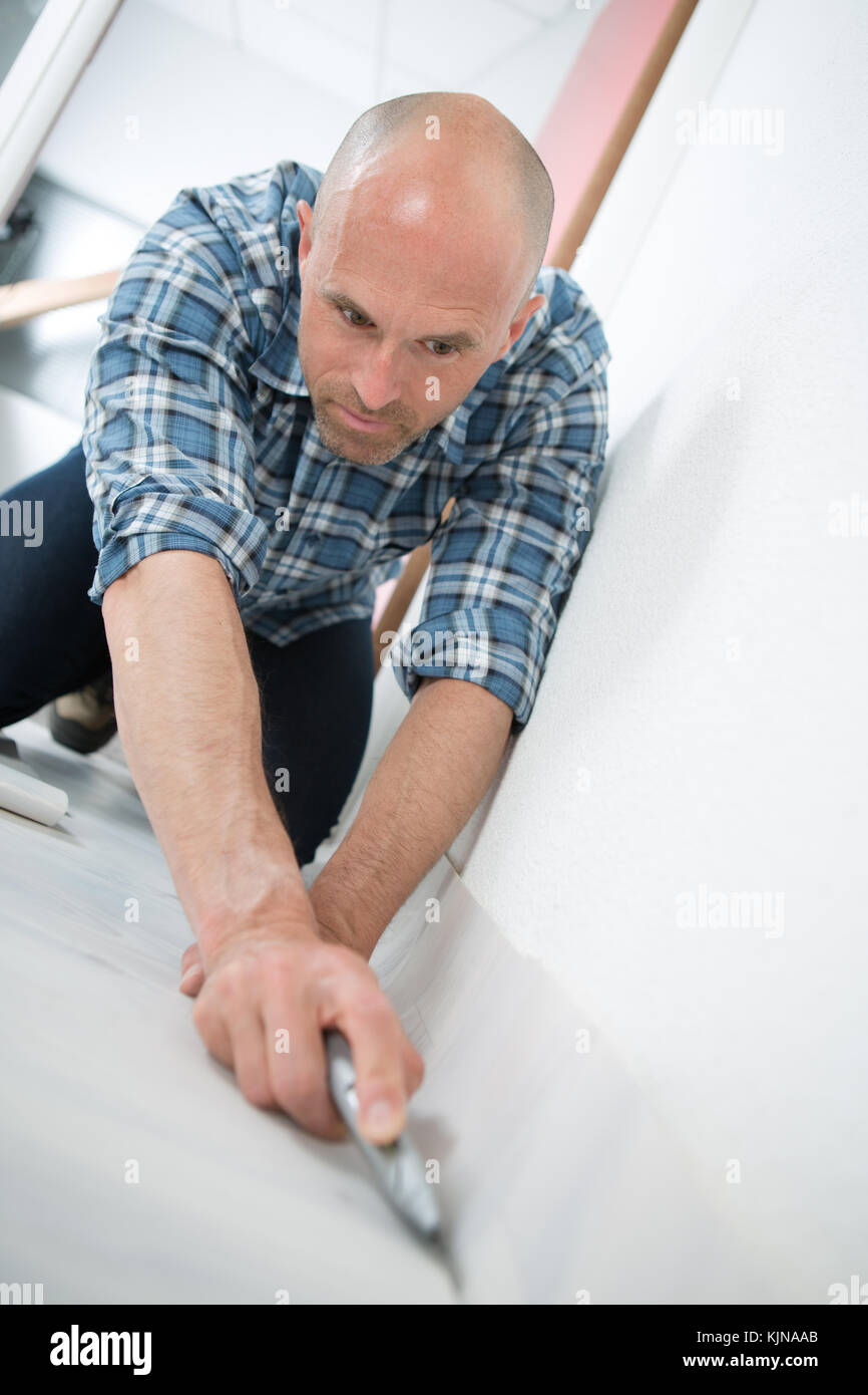 close-up of a craftsman fitting carpet on floor Stock Photo - Alamy