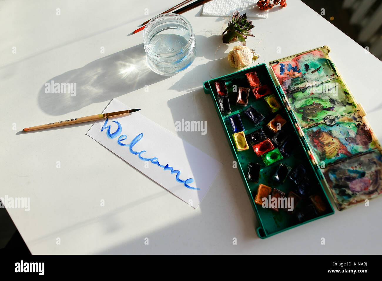 Calligraphic text Welcome, written in colors on white paper, whi Stock ...