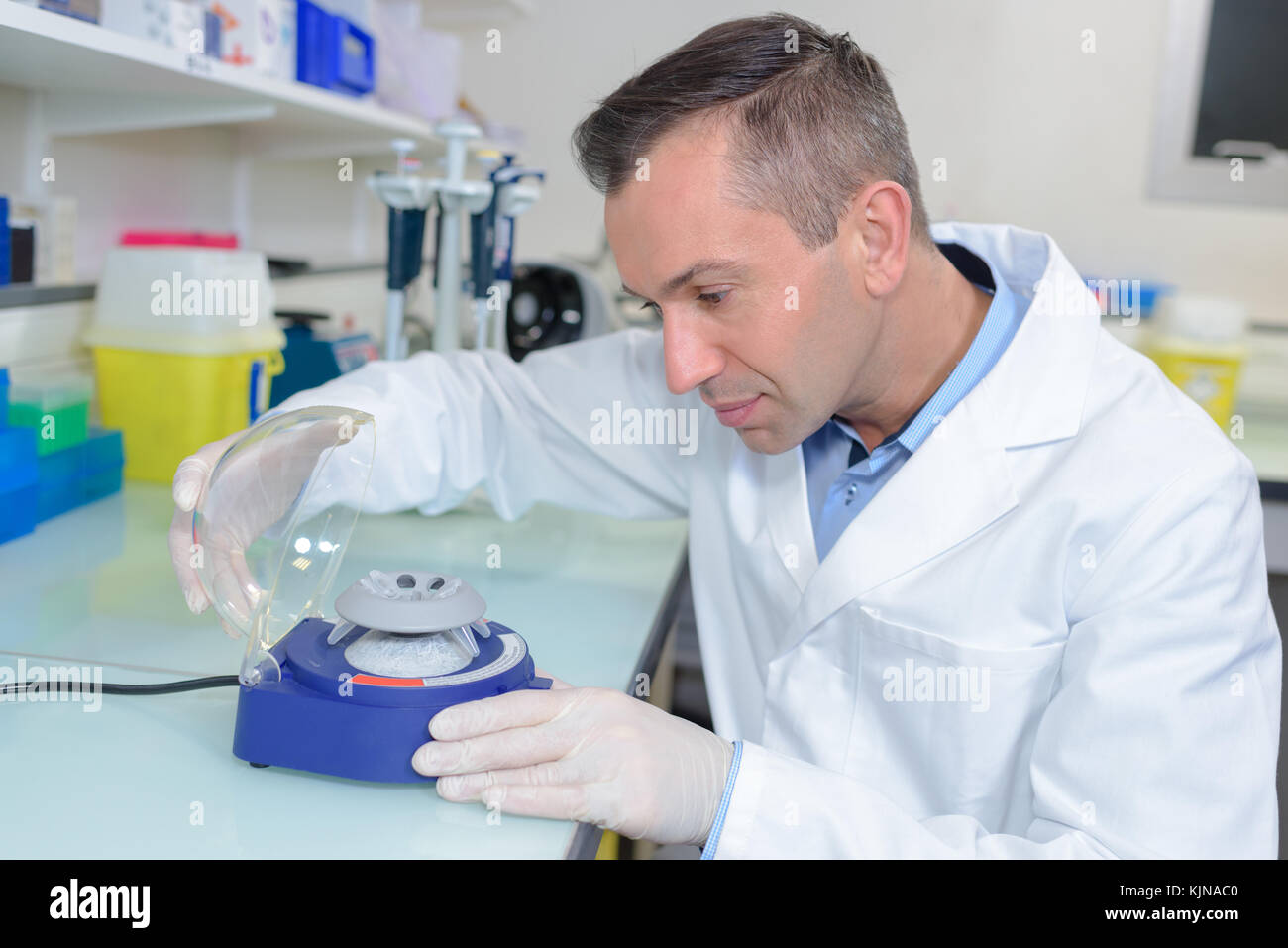 Lab technician using apparatus Stock Photo - Alamy