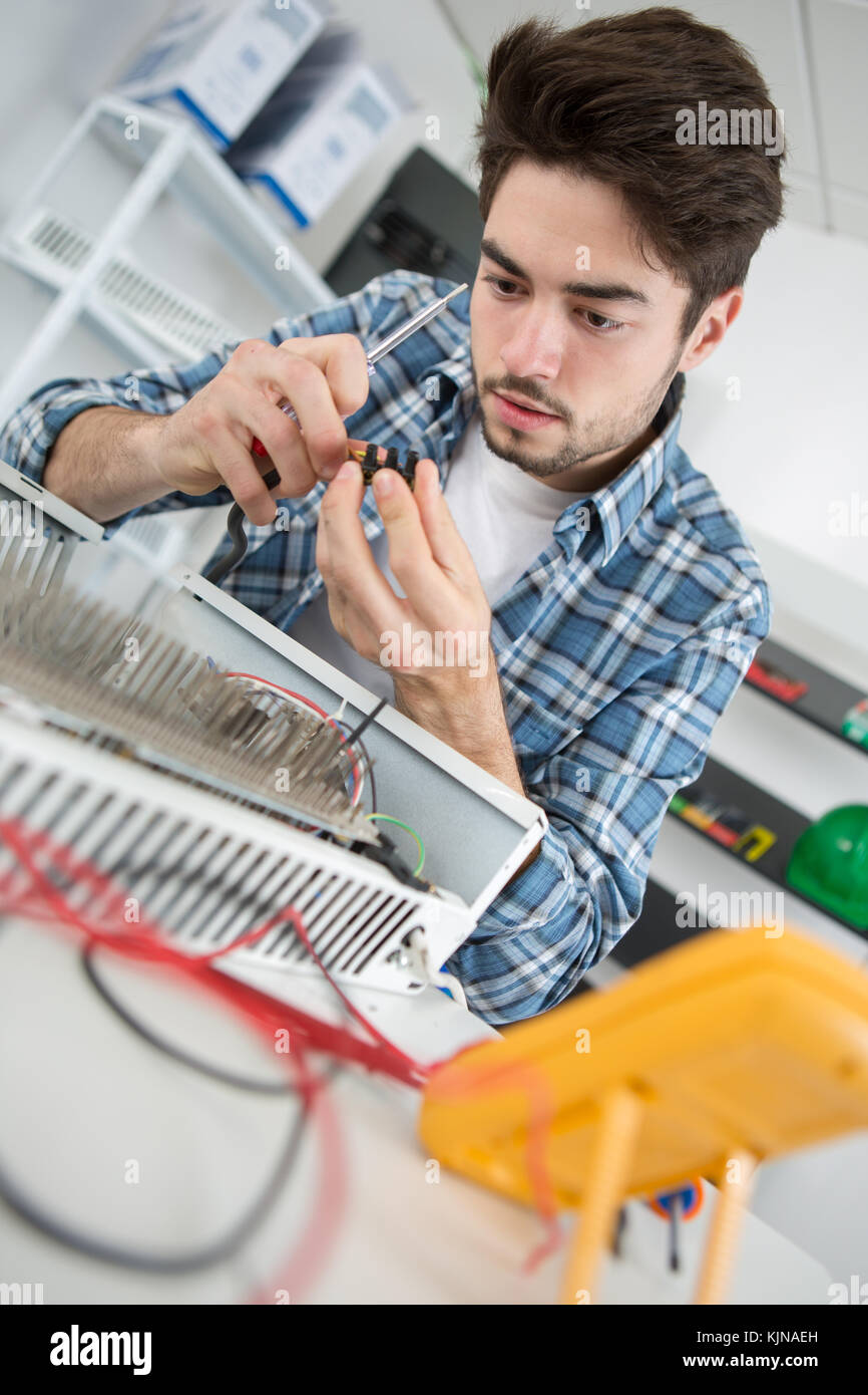 young man fixing radiator Stock Photo - Alamy