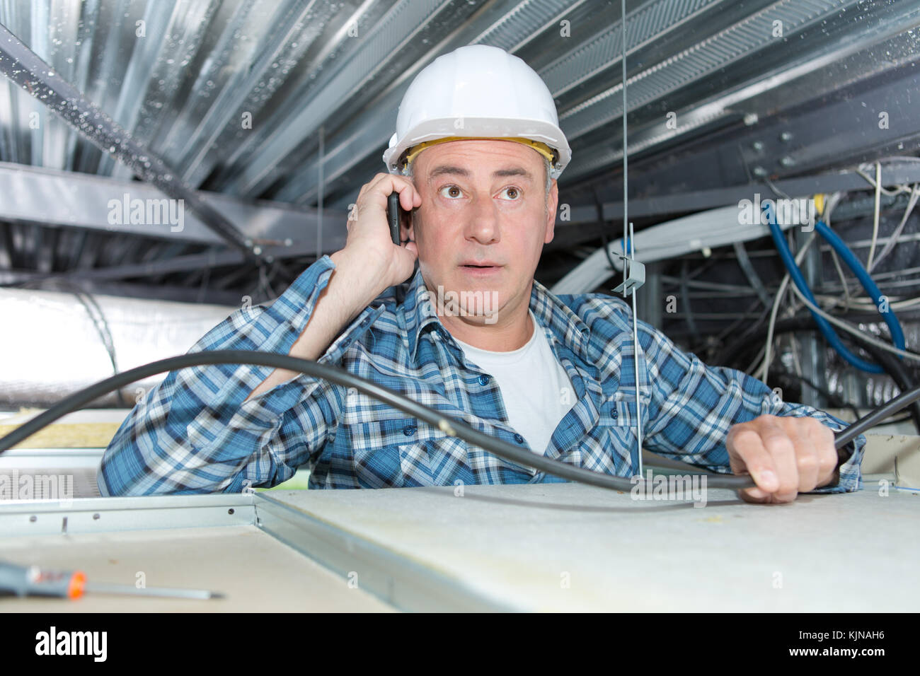 insulation installer on phone Stock Photo - Alamy