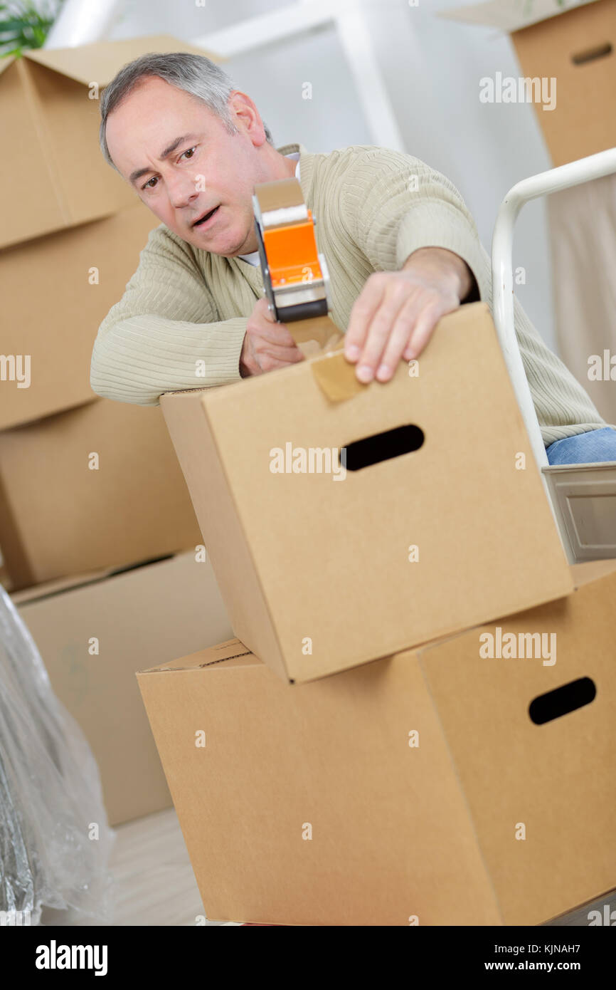 man taping the boxes Stock Photo - Alamy