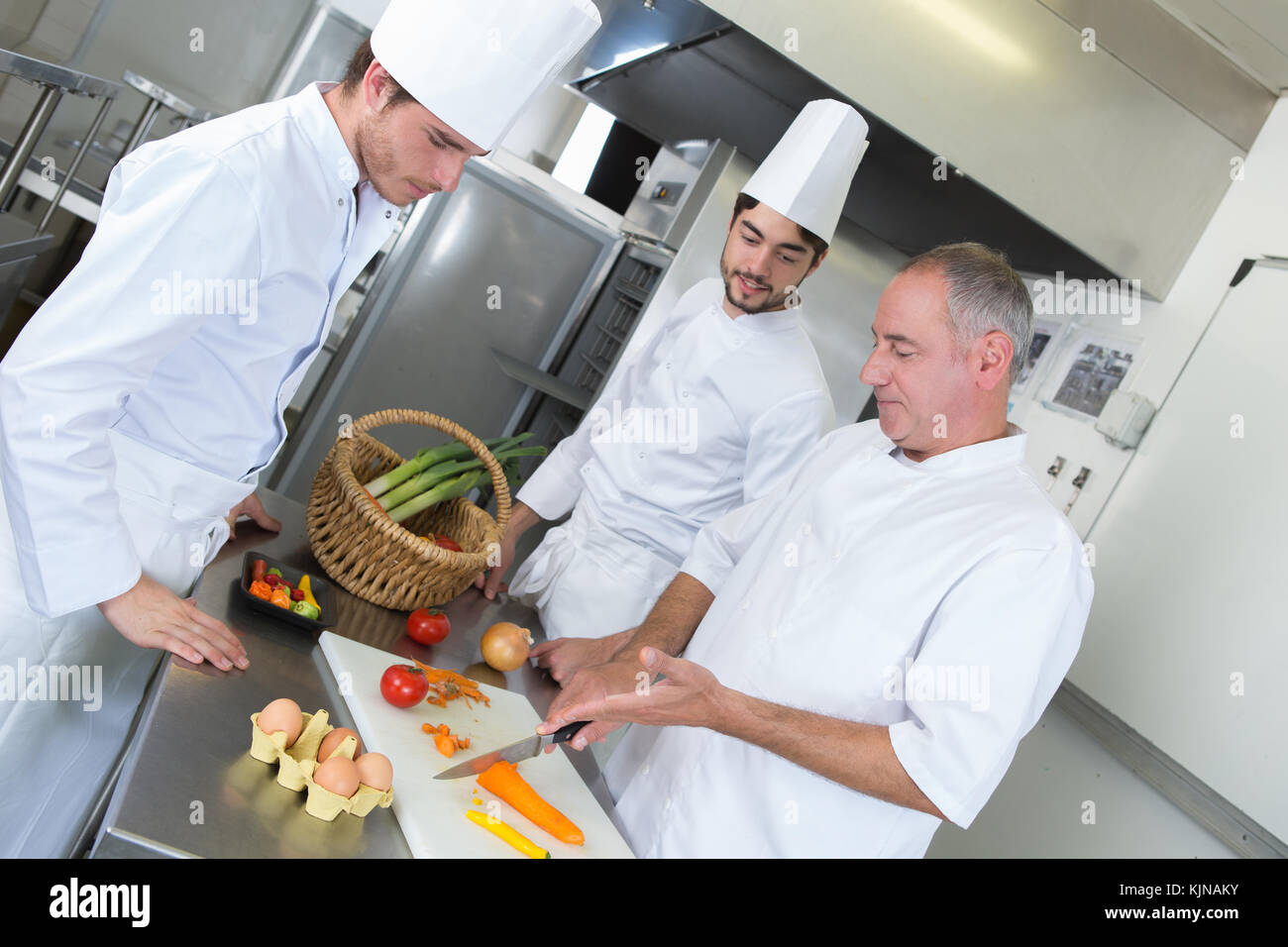 apprentices cooks learning with experienced chef Stock Photo - Alamy