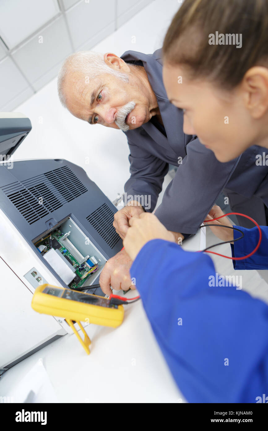 Workers testing appliance with multimeter Stock Photo - Alamy