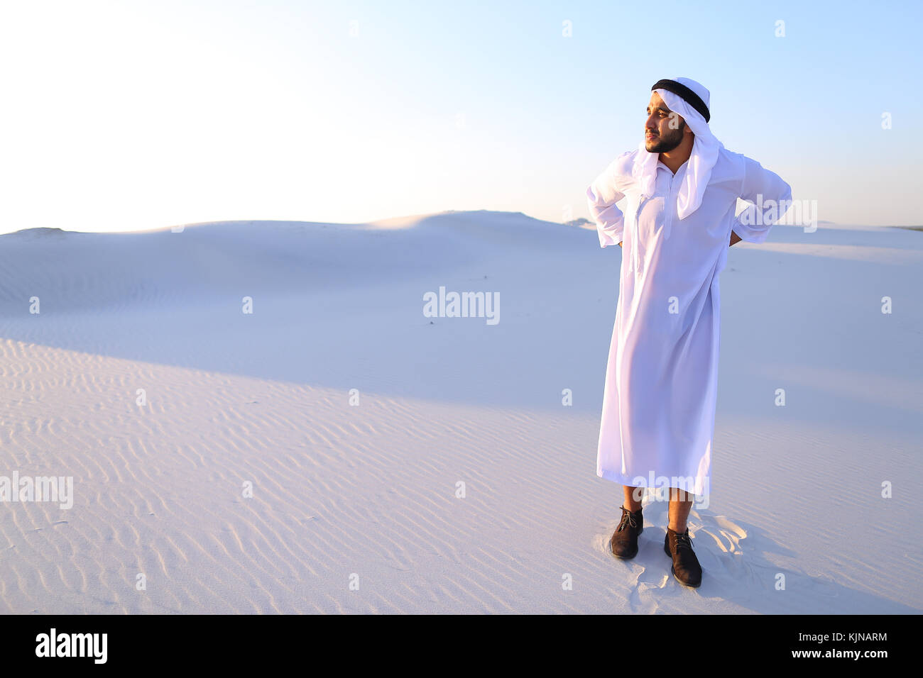 Handsome Arab sheik suffers from discomfort in back, standing in Stock ...