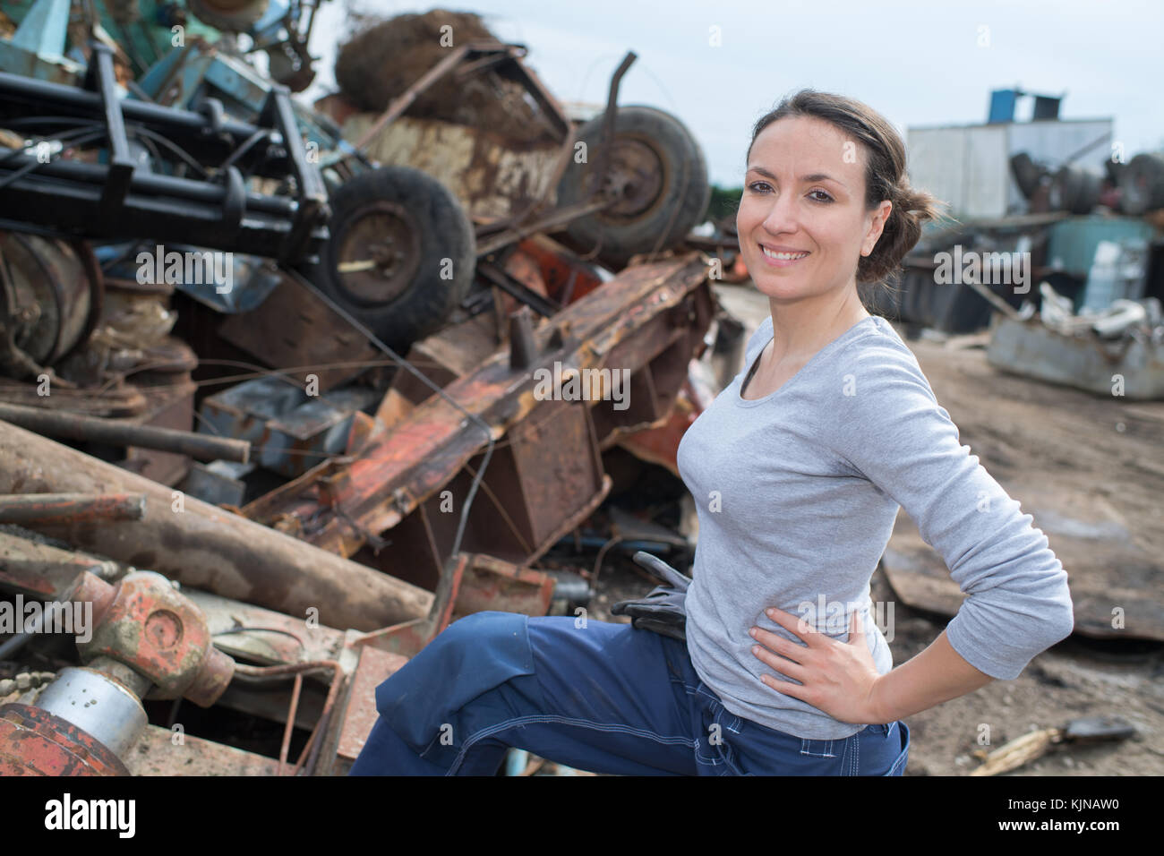 woman working at a car scrapper Stock Photo - Alamy