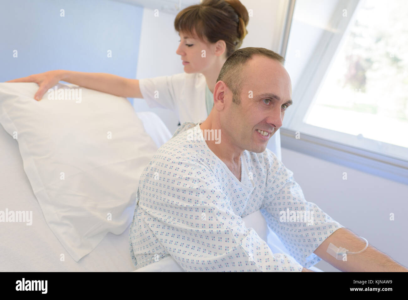 nurse helping patient in bed in hospital Stock Photo - Alamy