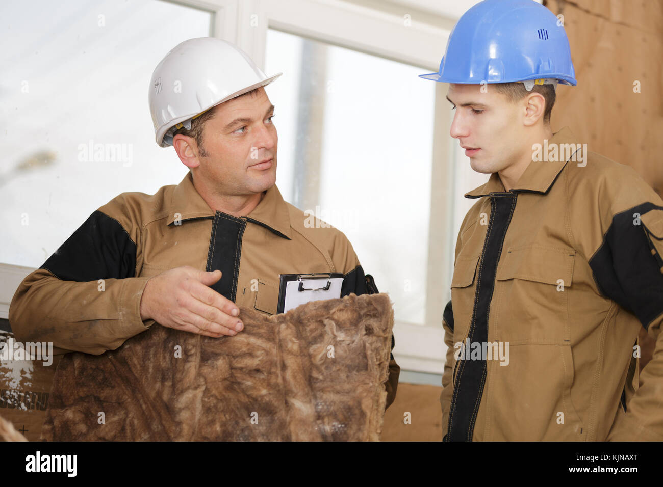 builder showing apprentice an absorber sandwich panel for wall Stock ...